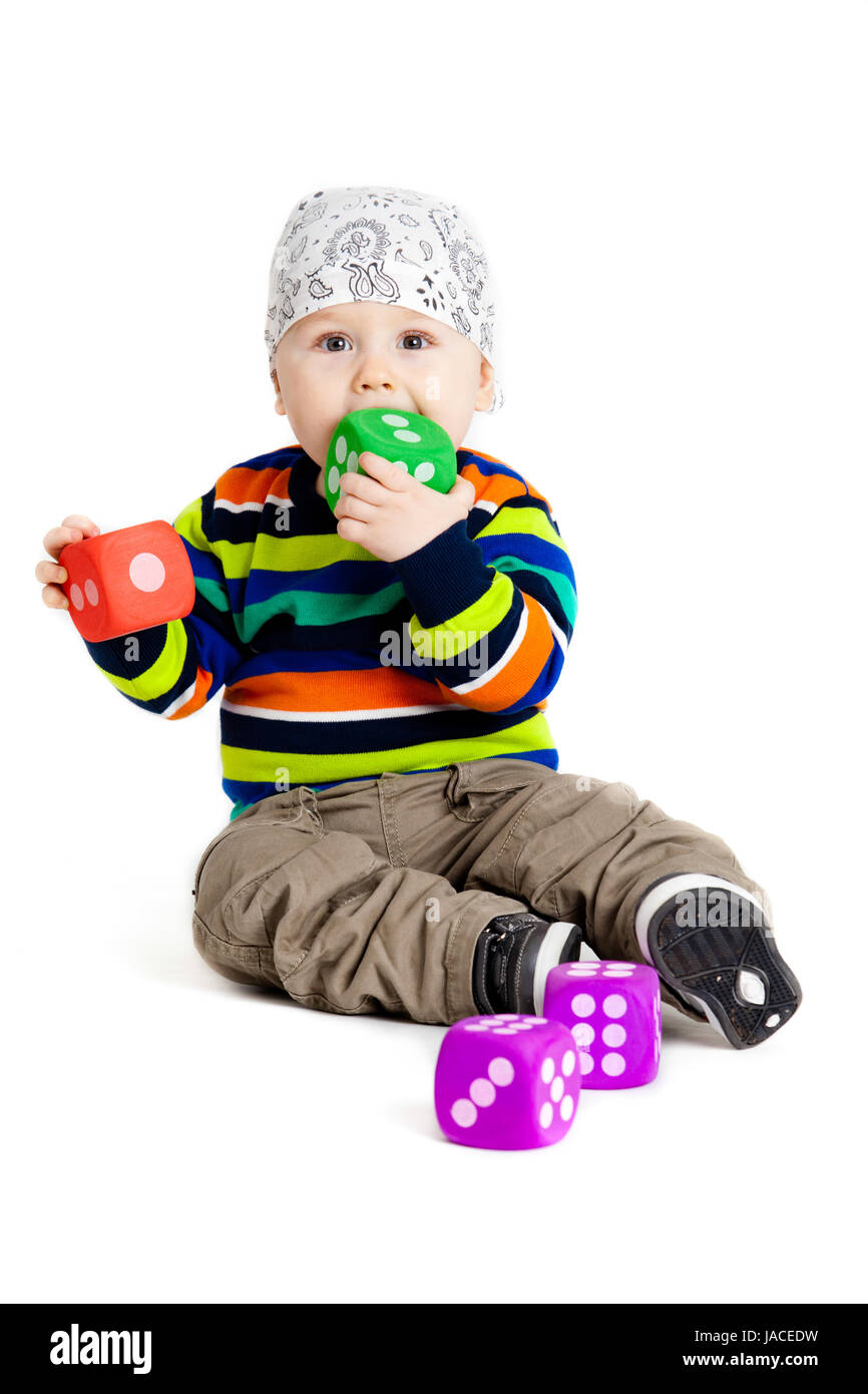 baby is playing with toys over white background. Funny little kid ...