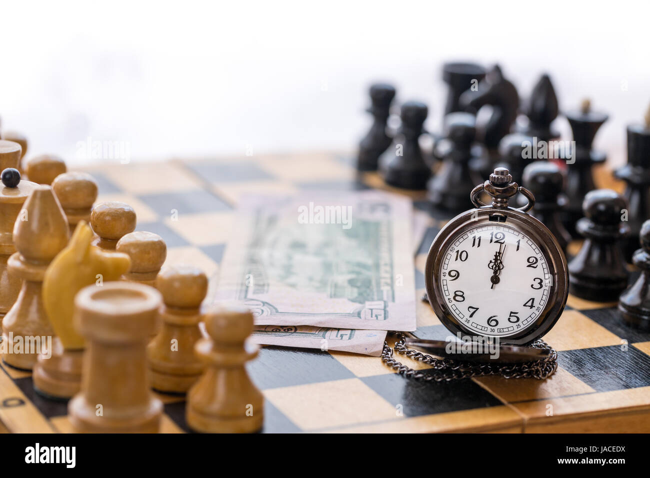Vintage pocket watch money and chess pieces on chess board Stock Photo ...