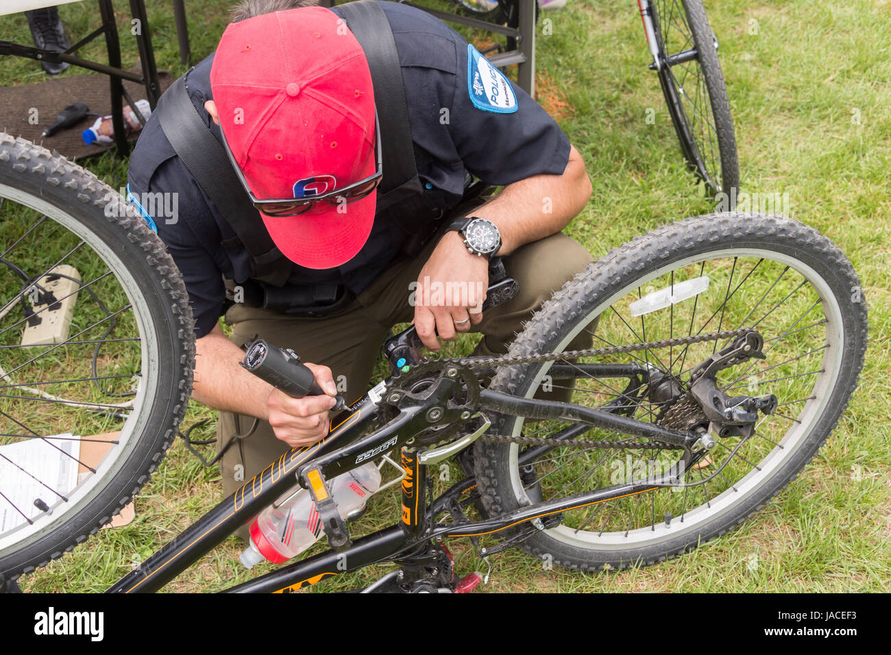 Montreal, Canada - 4 June 2017: A police officer is engraving a bike ...