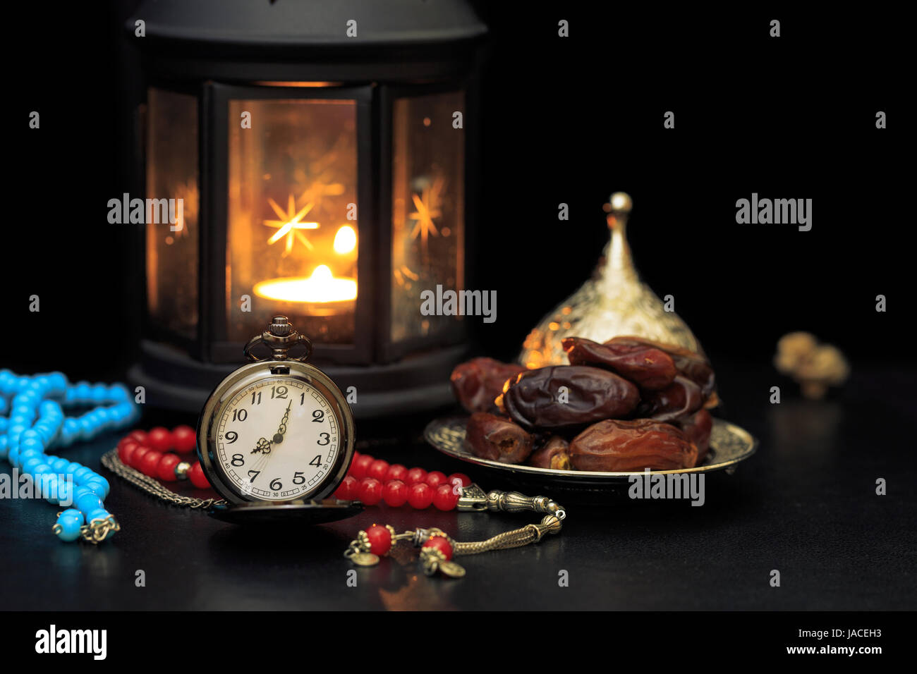 Ramadan concept with dates, pocket watch, rosary and lantern in ...