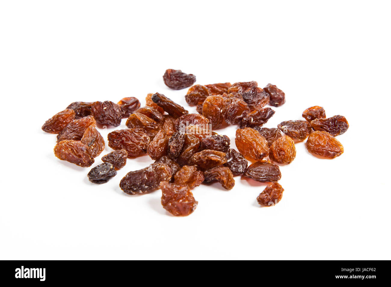 brown raisins on a white background Stock Photo - Alamy