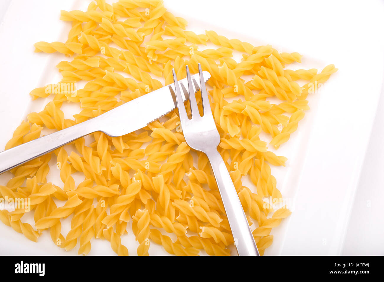 Dry pasta on a white Plate Stock Photo - Alamy