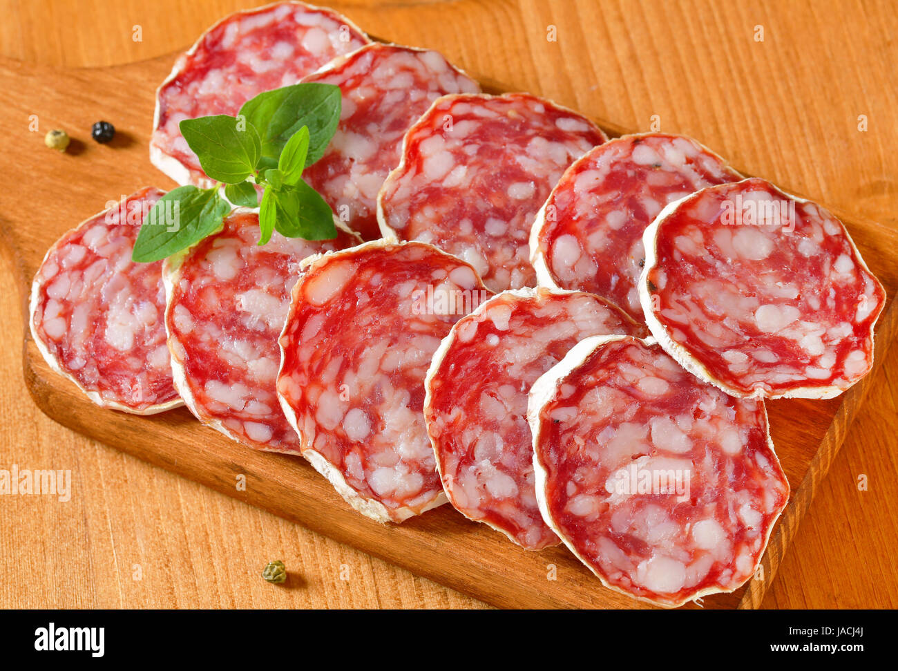 Sliced French Saucisson Sec on cutting board Stock Photo - Alamy