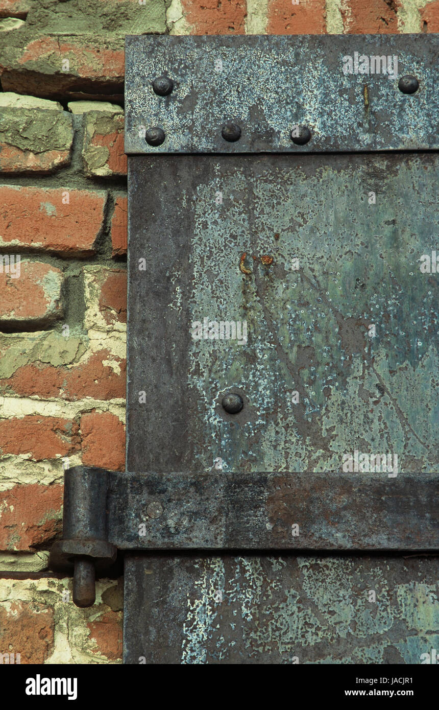 Rusty iron door against red brick Stock Photo - Alamy