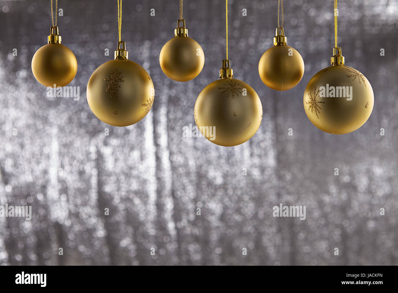 A group of christmas decoration ball of different Sizes hanging against ...