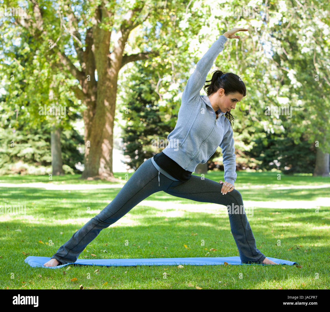 fitness model exercising yoga in the park during fall Stock Photo - Alamy