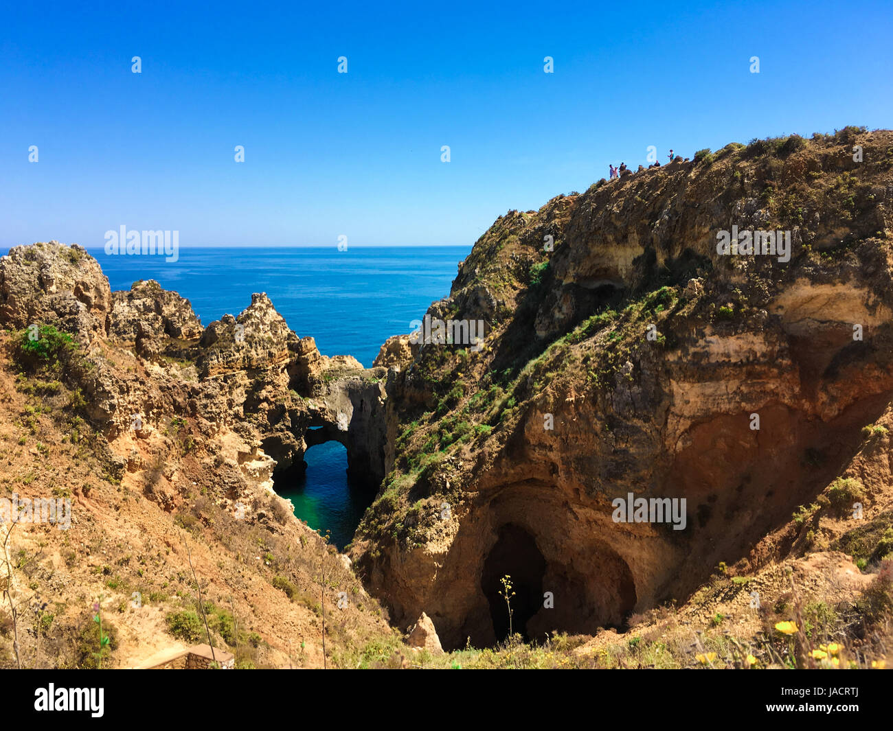 Portuguese Beach with sunbathing People and Surfers on a beautiful ...