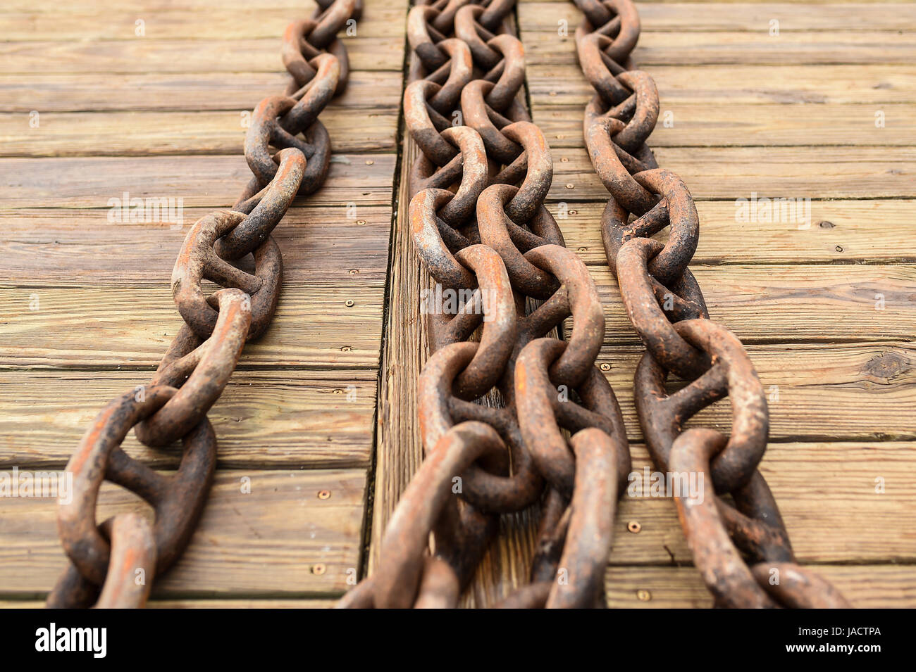 Ships anchor chain on a wooden pier in the harbor. Sardinia, Italy ...