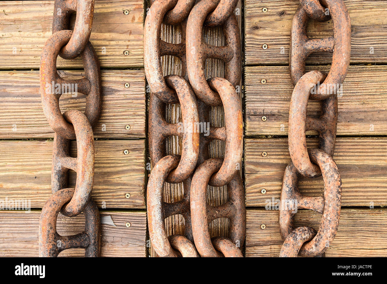 Ships anchor chain on a wooden pier in the harbor. Sardinia, Italy ...