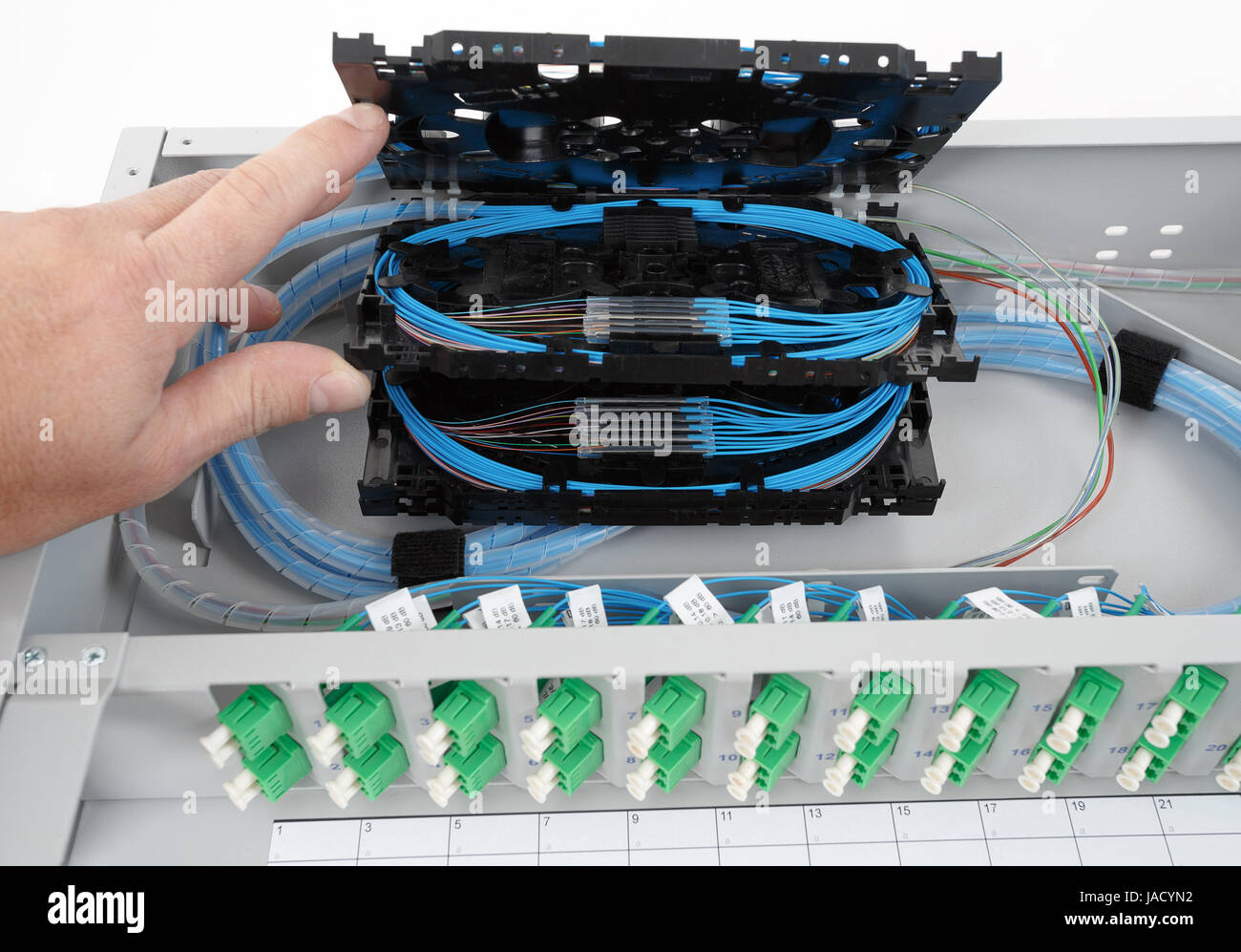 stack of fiber optic splice cassettes with protection sleeve and blue ...