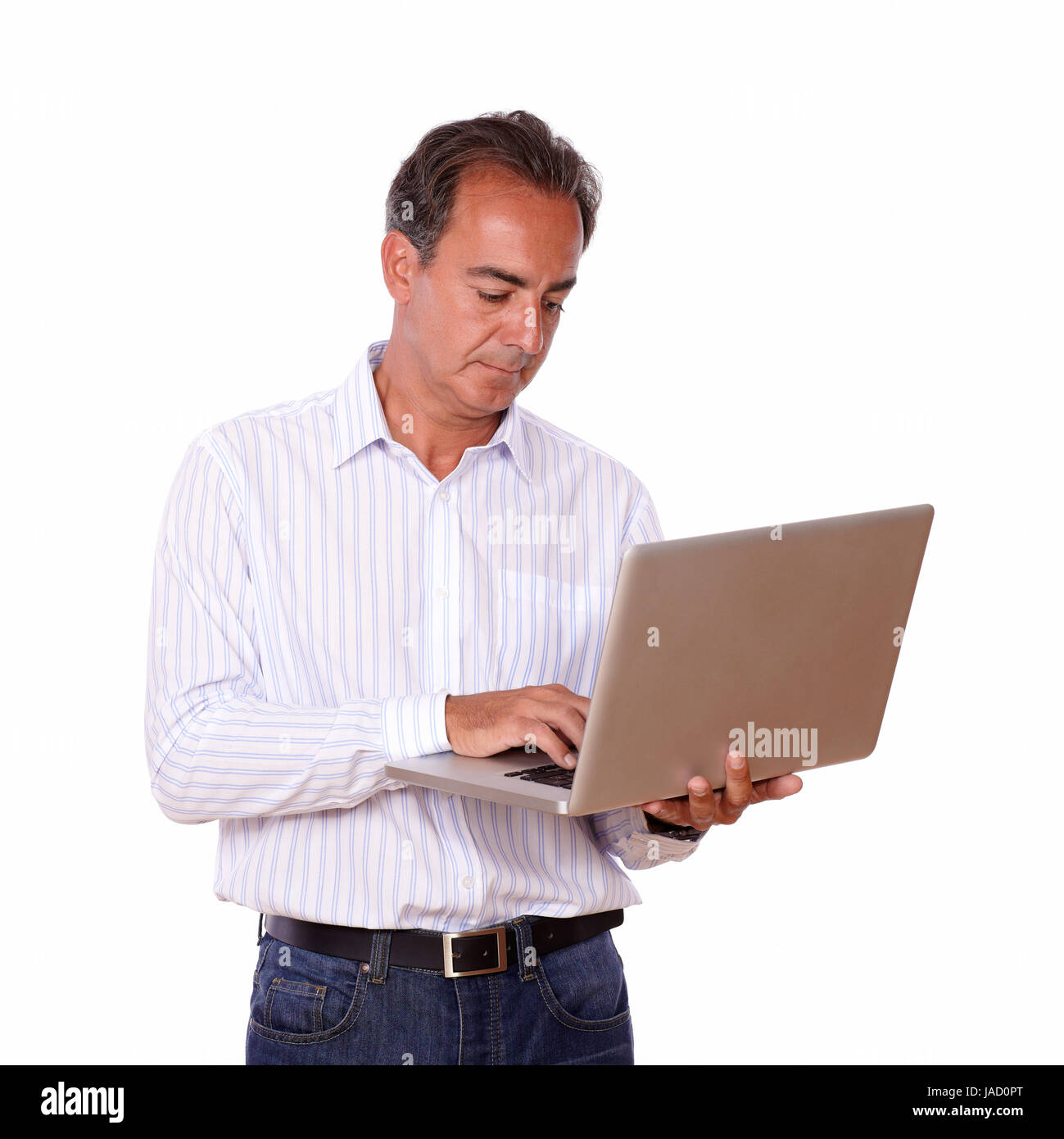 Portrait of a hispanic man working with his laptop computer while ...
