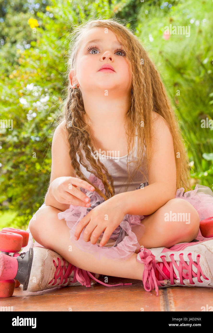 Girl Sitting Down Looking Up At The Sky