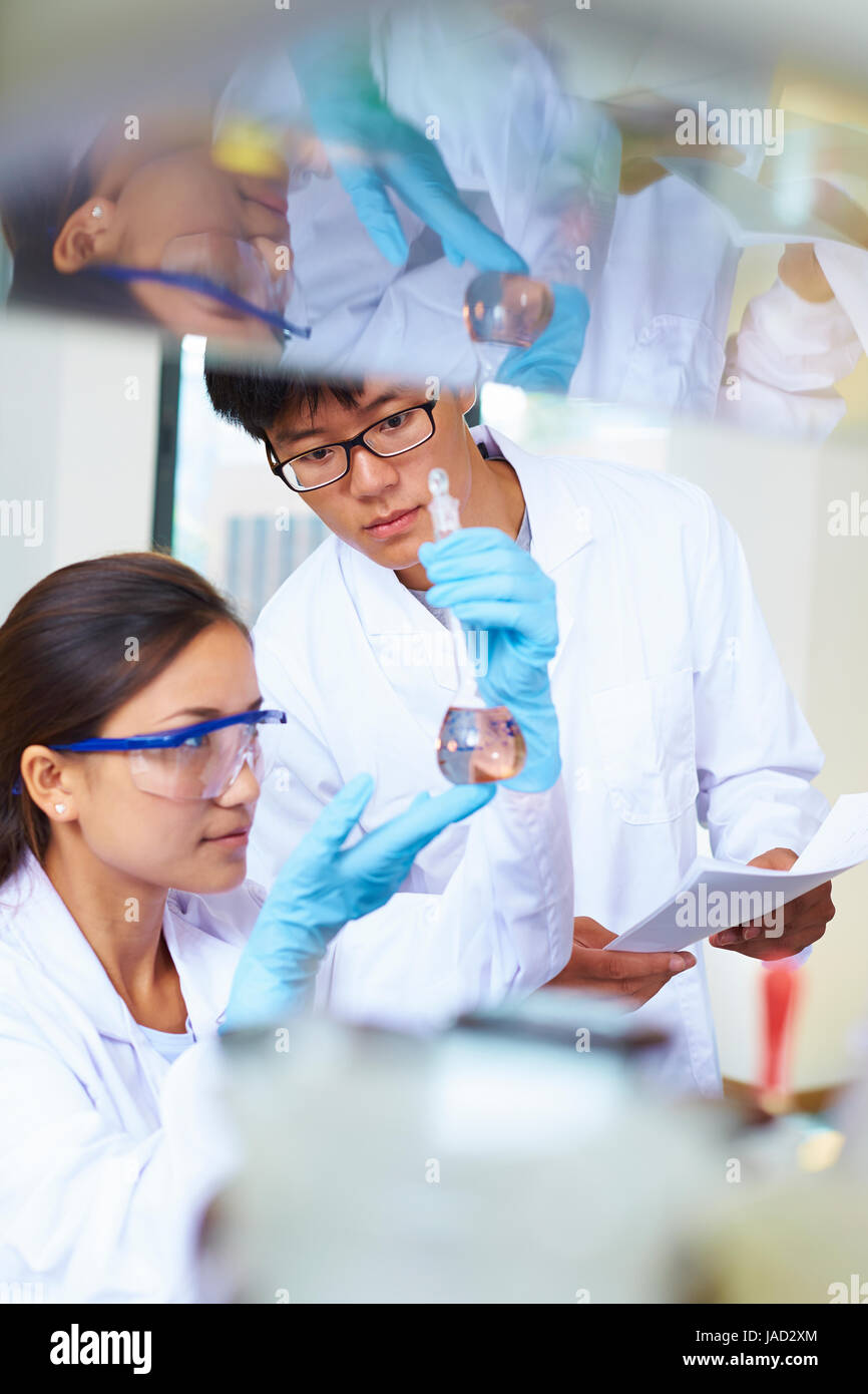Two Chinese Laboratory scientist working at lab with test tubes Stock ...