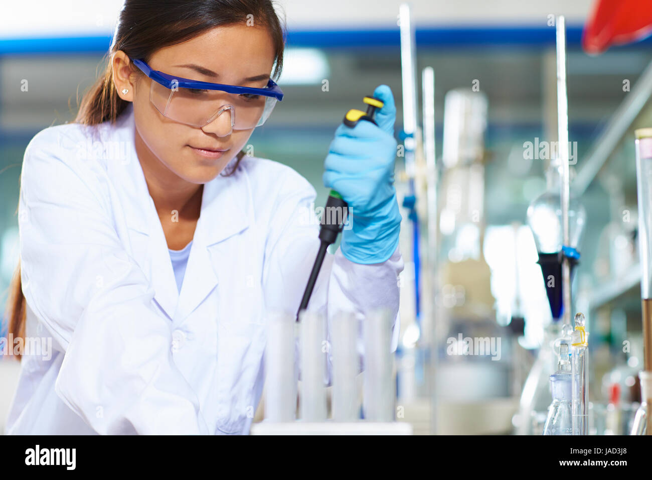 One Female Chinese Laboratory scientist working at lab with test tubes ...