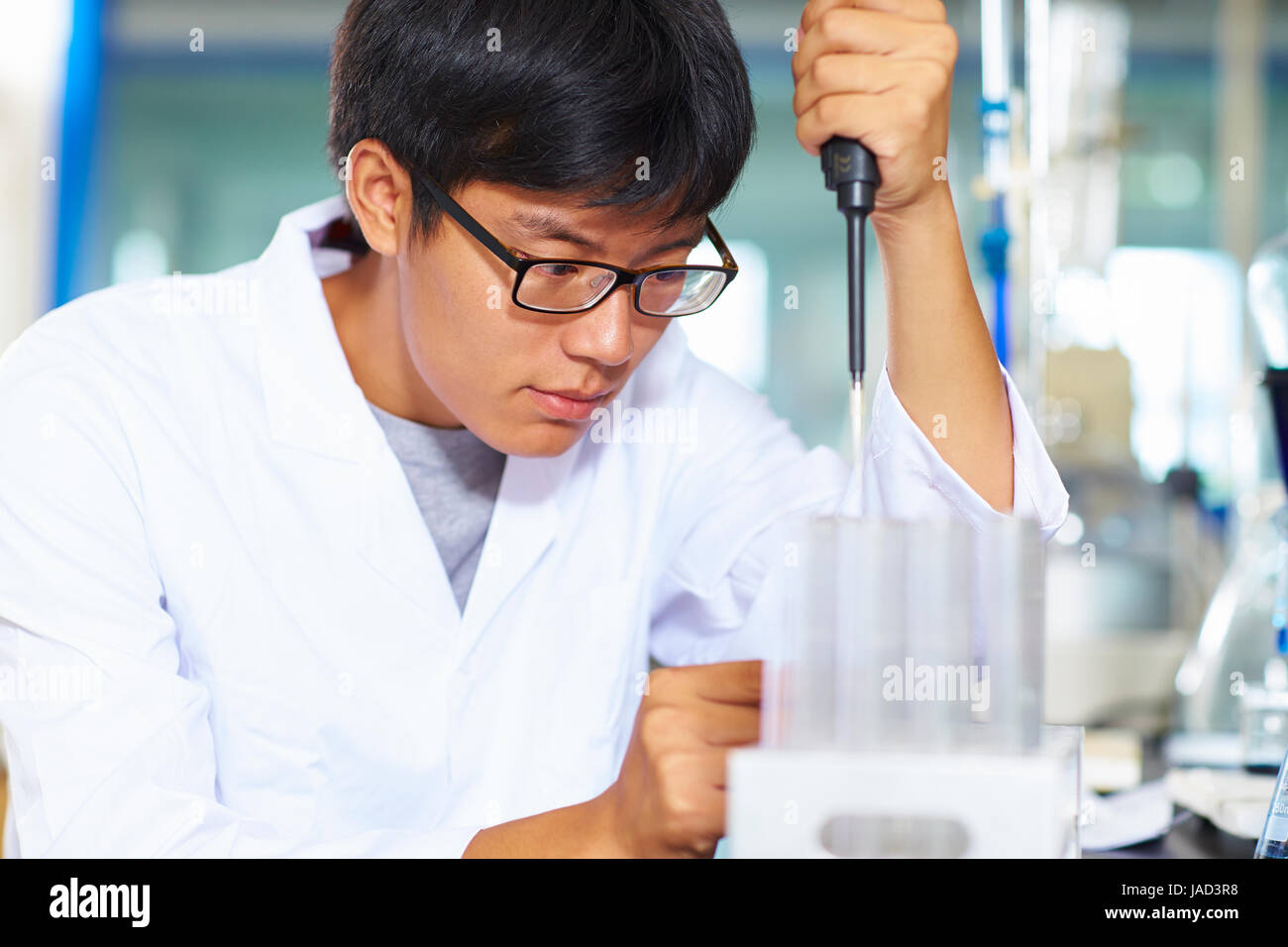 One male Chinese Laboratory scientist working at lab with test tubes ...