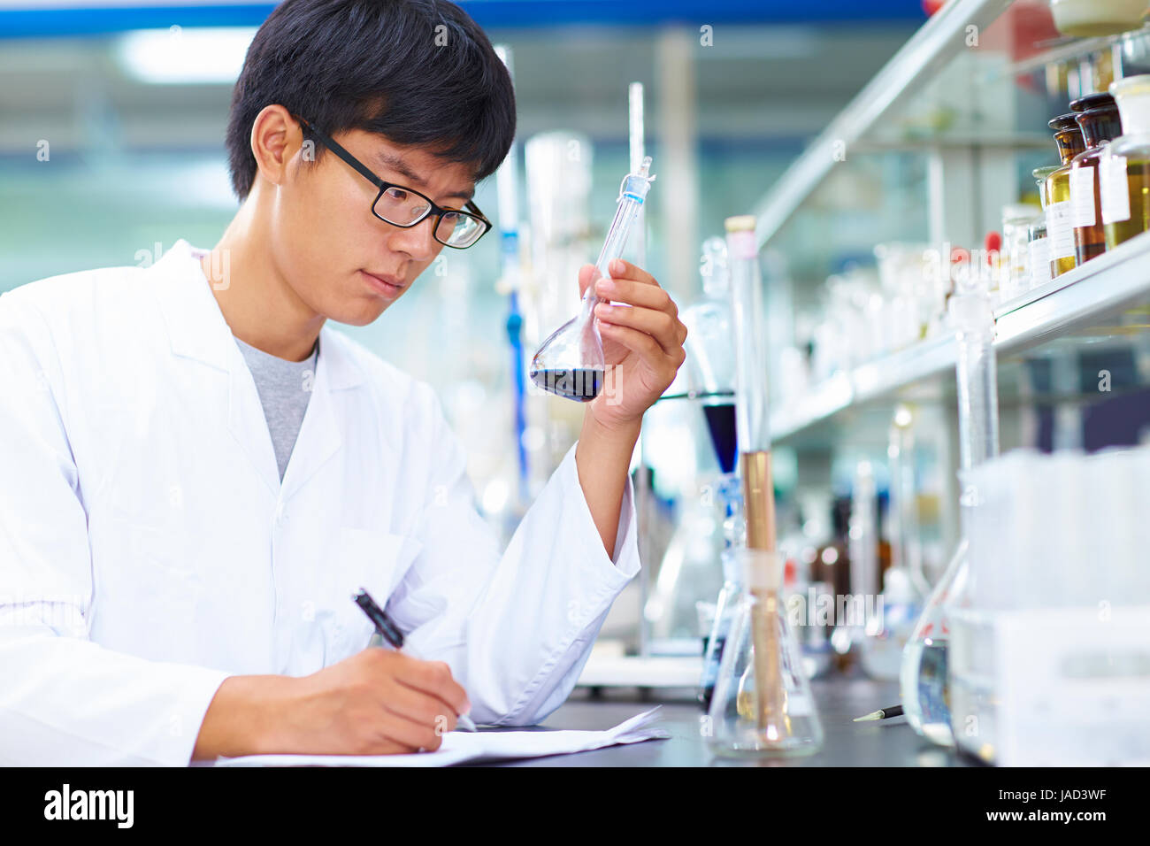 One male Chinese Laboratory scientist working at lab with test tubes ...