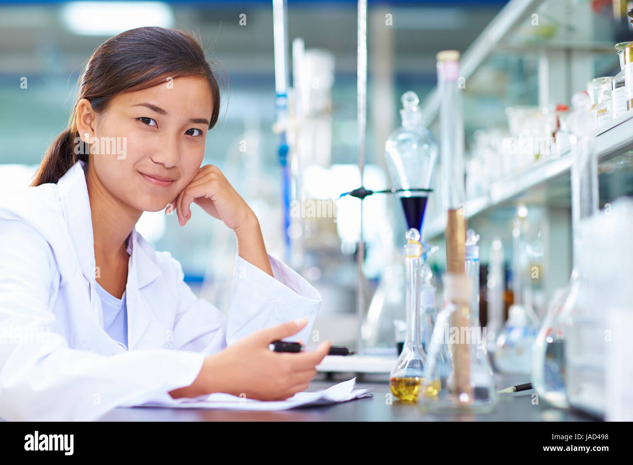 One Female Chinese Laboratory scientist working at lab with test tubes ...