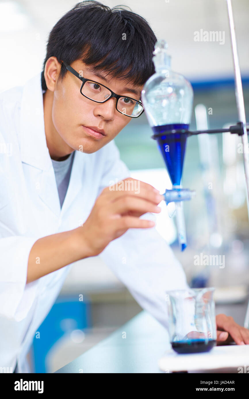 One male Chinese Laboratory scientist working at lab with test tubes ...
