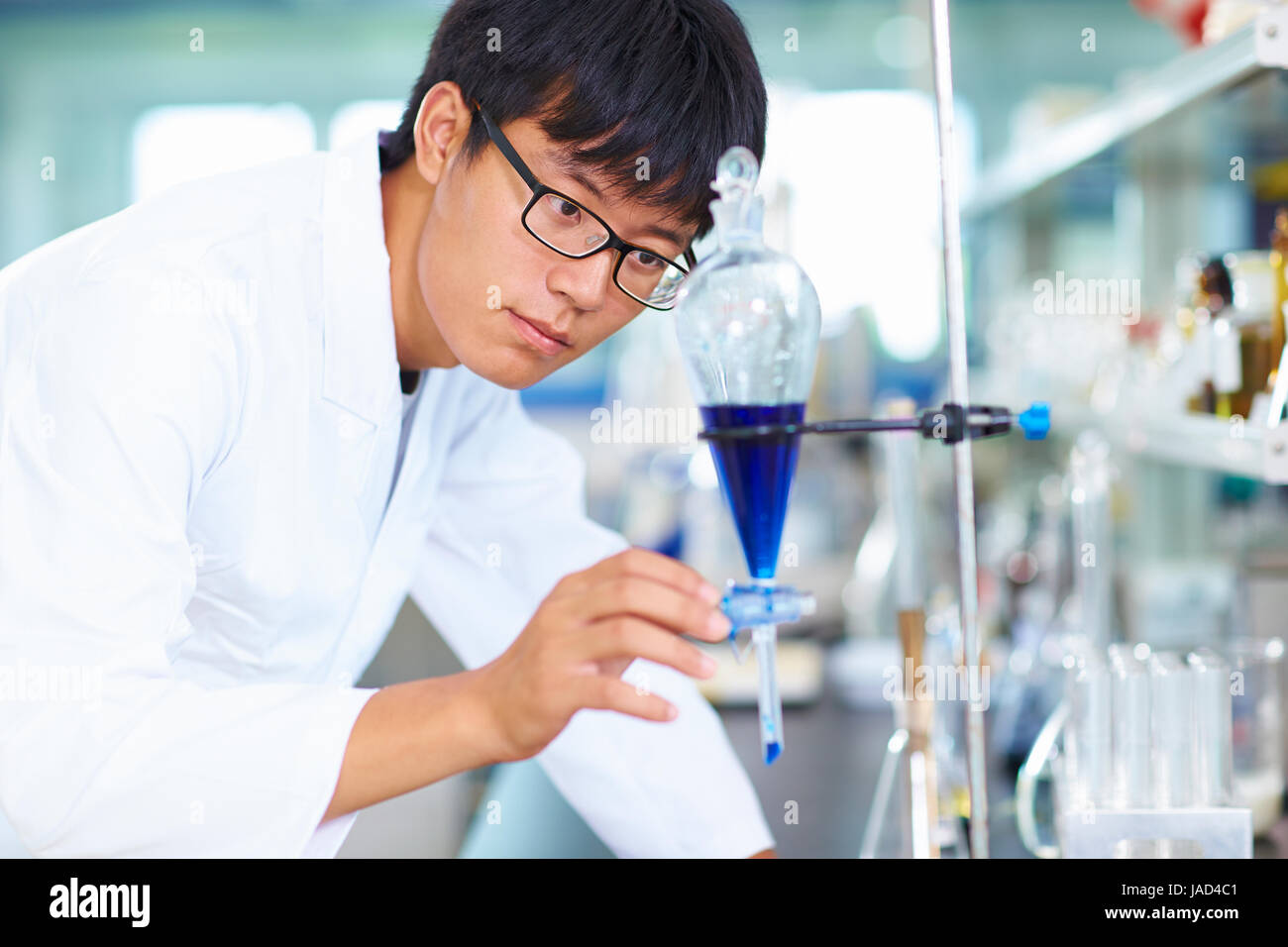 One male Chinese Laboratory scientist working at lab with test tubes ...