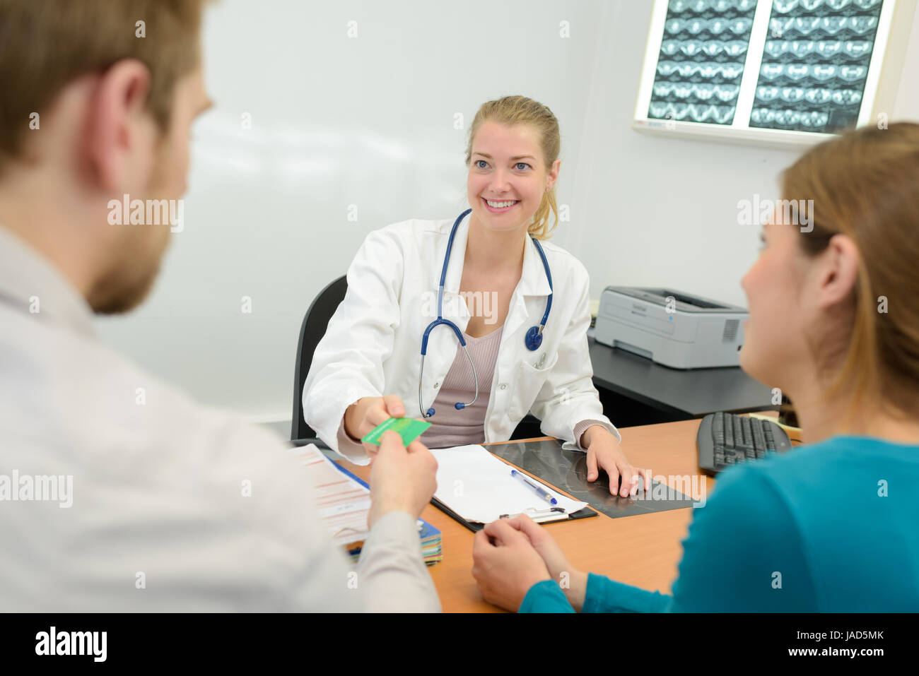 female doctor talking with young couple Stock Photo - Alamy