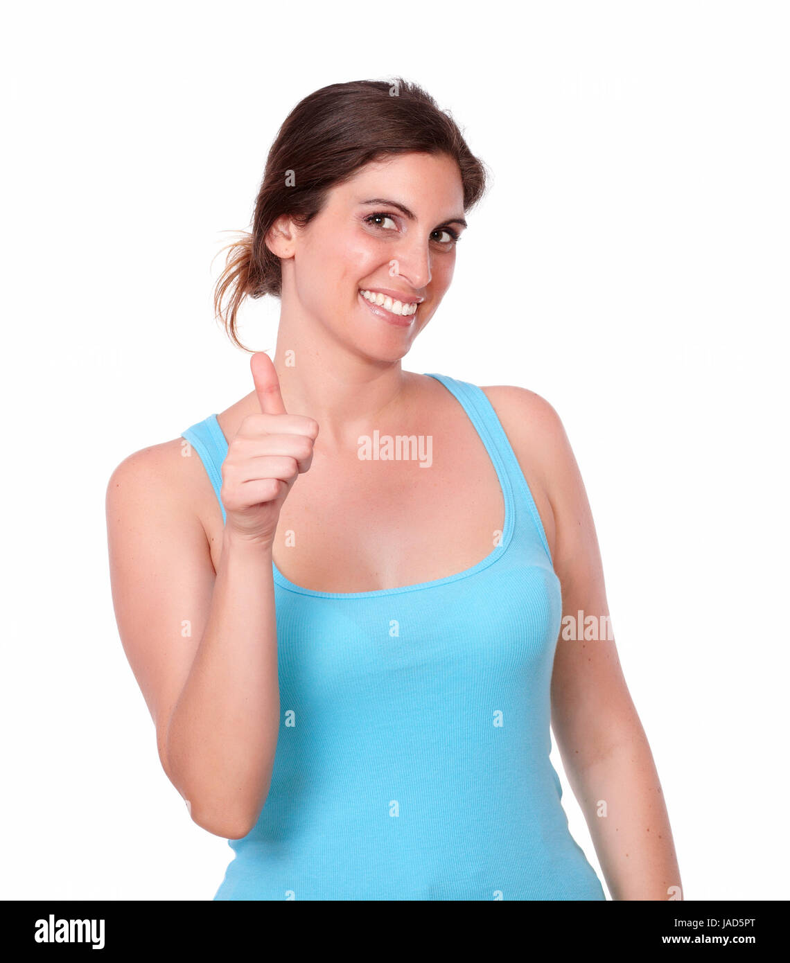 Portrait of a fit young woman in gym clothing standing with thumb up on ...