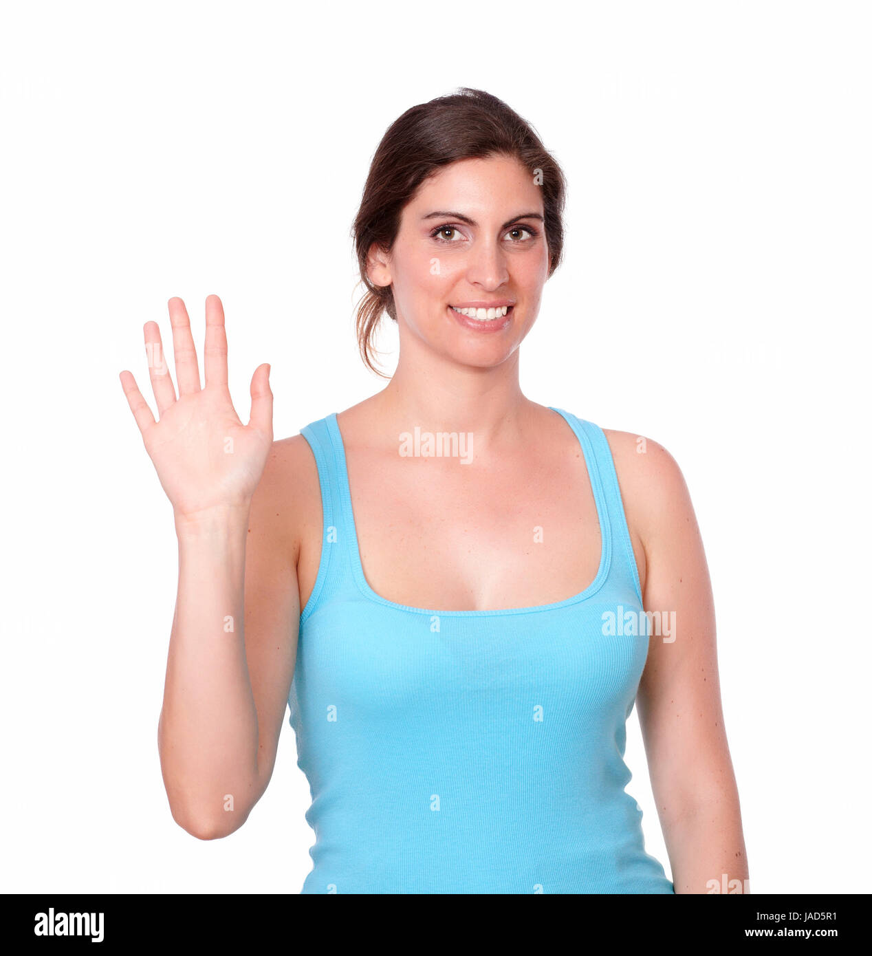 Portrait of a fashionable sporty female gesturing a greeting with hand ...