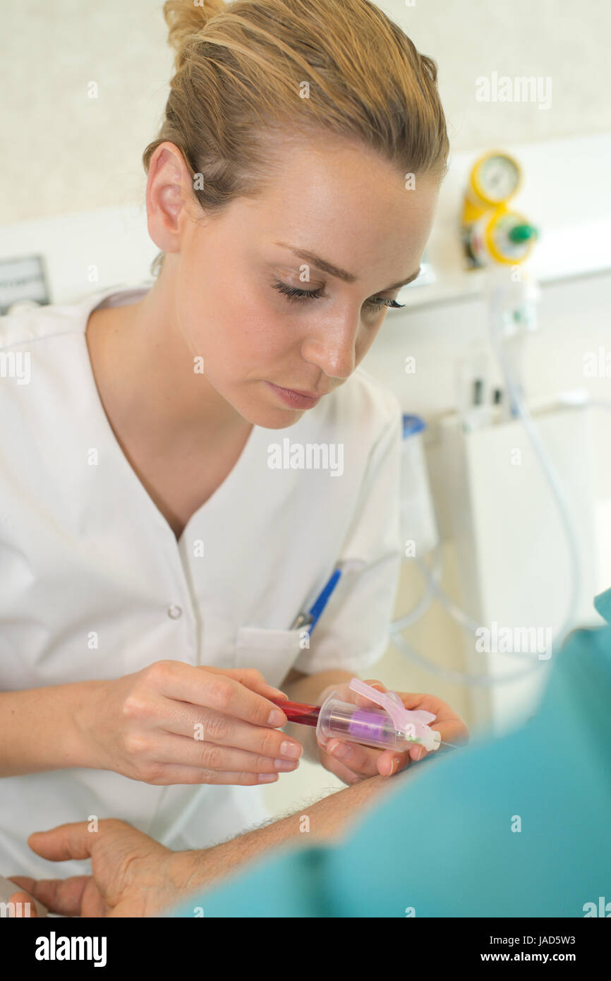 nurse taking a blood sample from patient Stock Photo - Alamy
