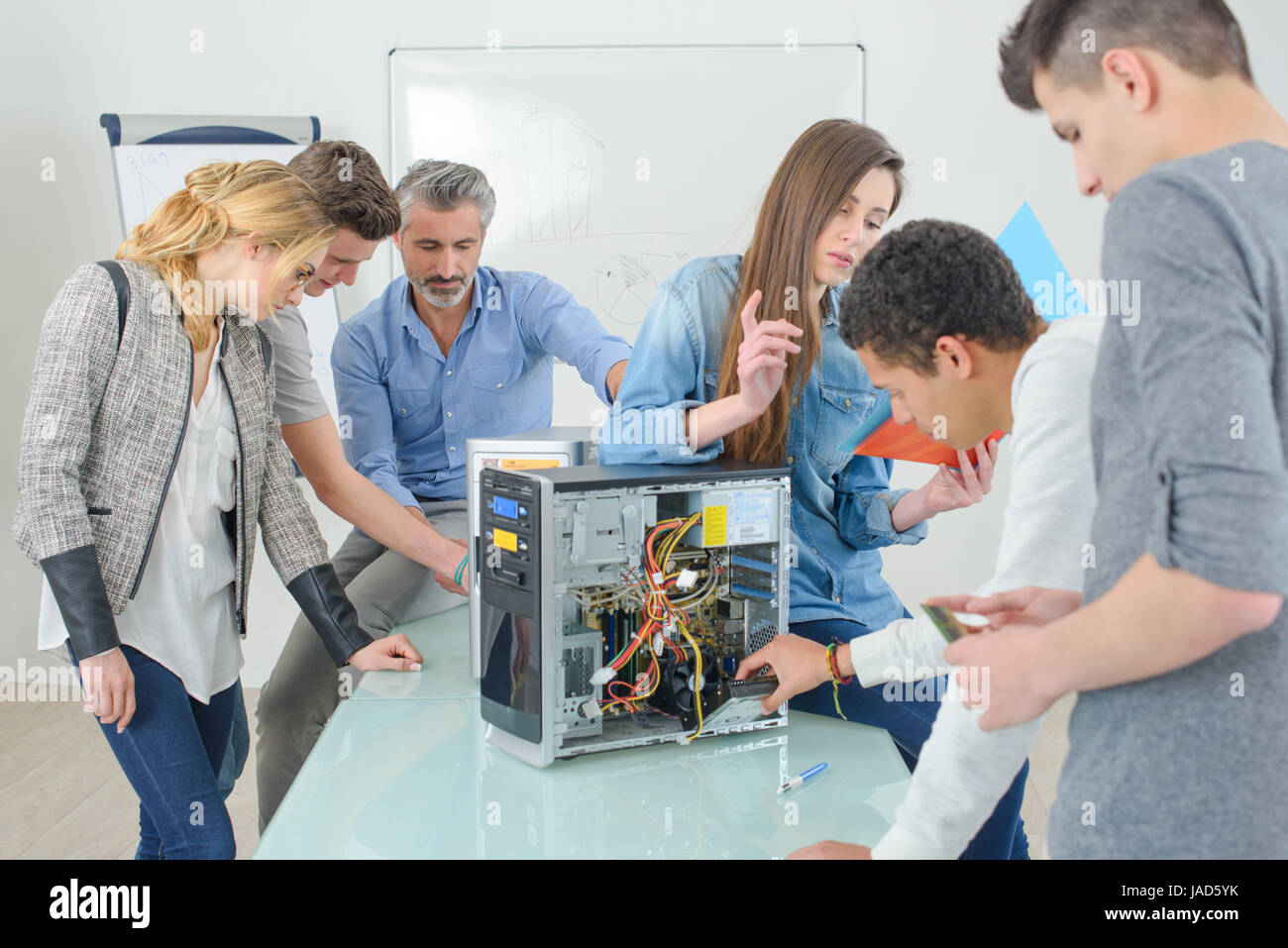 group of students fixing a computer during an it class Stock Photo - Alamy