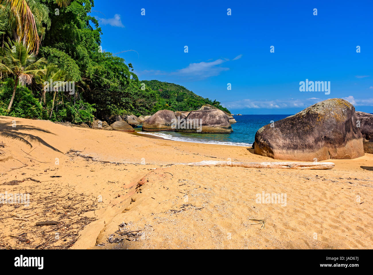 Deserted and unspoilt beach with its limpid and transparent waters that ...