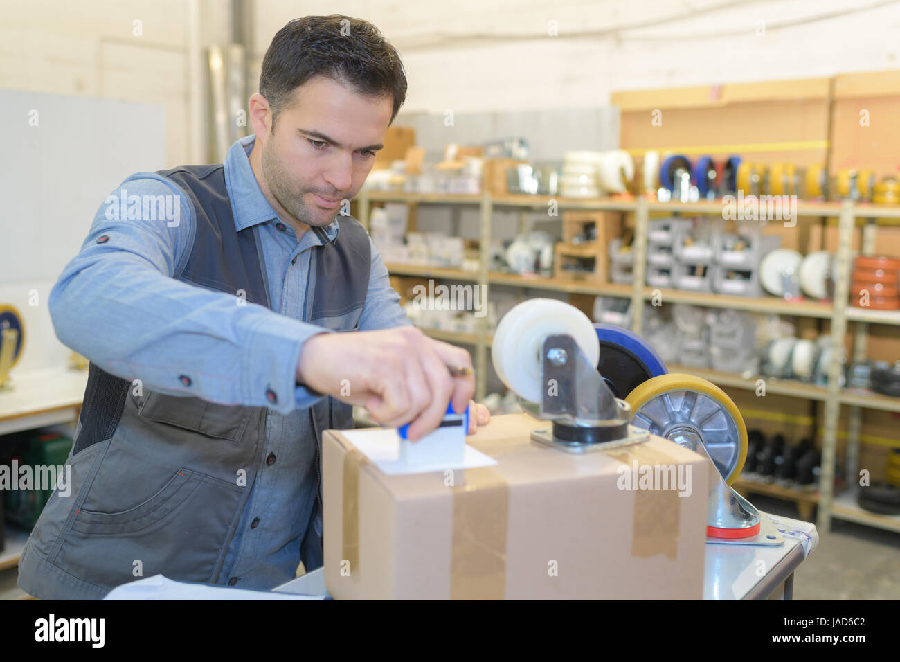warehouse worker preparing a shipment in a large warehouse Stock Photo ...