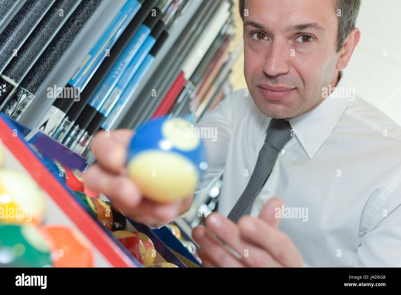 man holding a billiard ball Stock Photo - Alamy