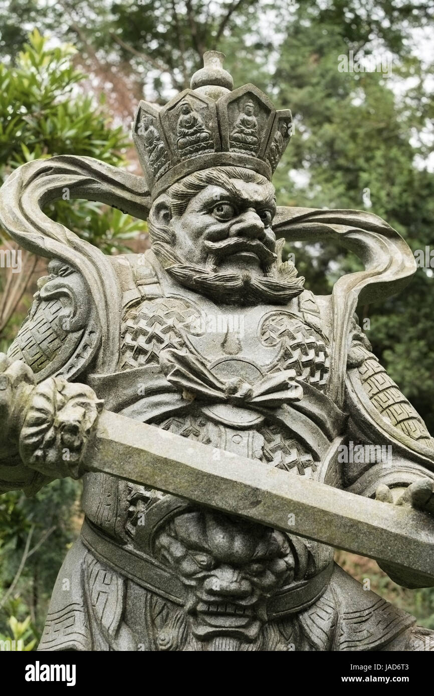 Aged asian god stone statue Stock Photo - Alamy
