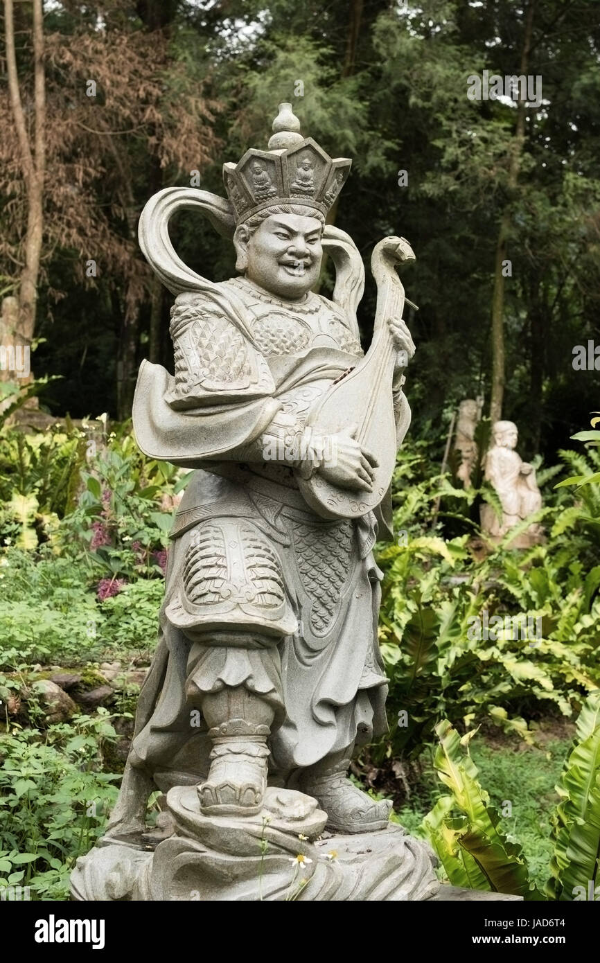 Aged asian god stone statue Stock Photo - Alamy