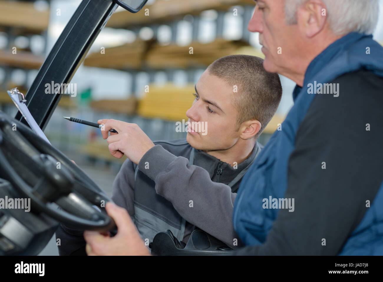 teacher helping student training to be car mechanics Stock Photo - Alamy