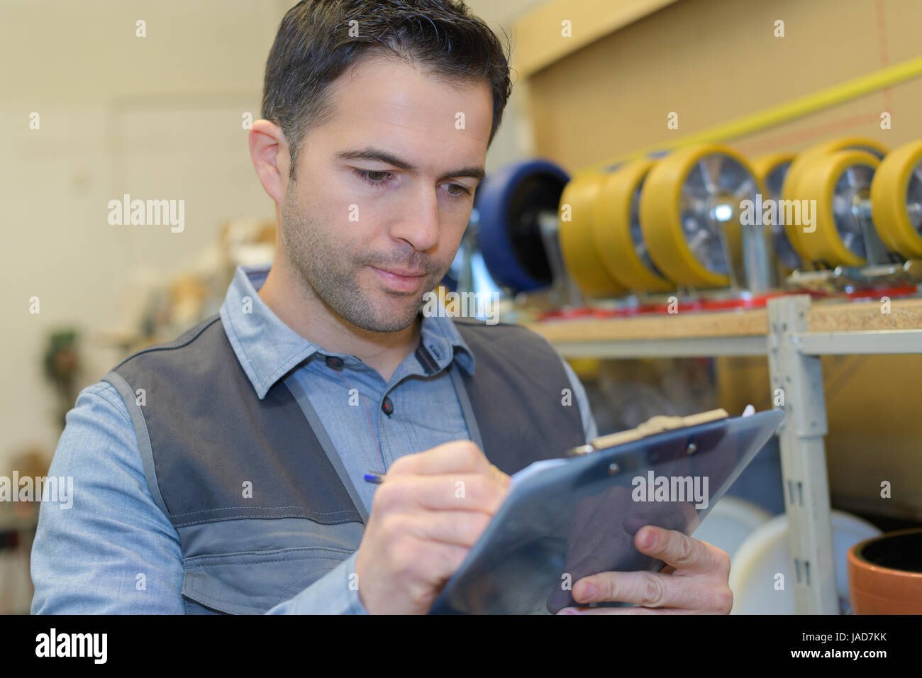 man writing a report down in his clipboard Stock Photo - Alamy