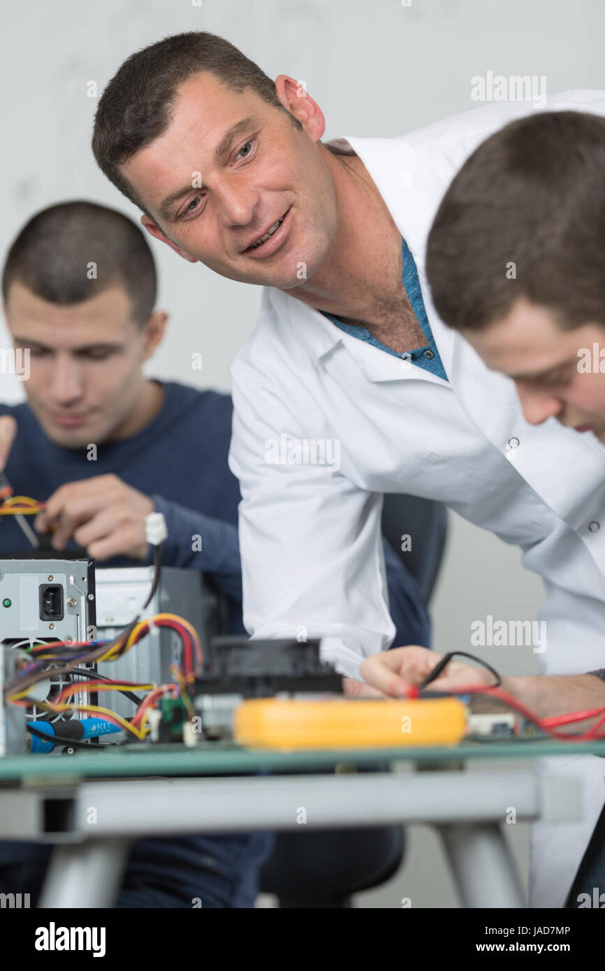 students in technology fixing computer processing Stock Photo - Alamy