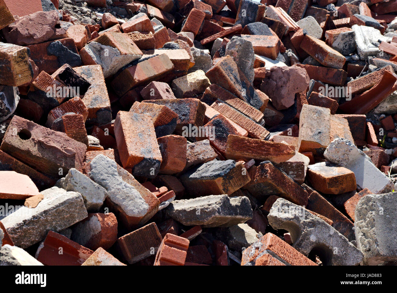 Messy pile of jagged red bricks and debris background Stock Photo - Alamy