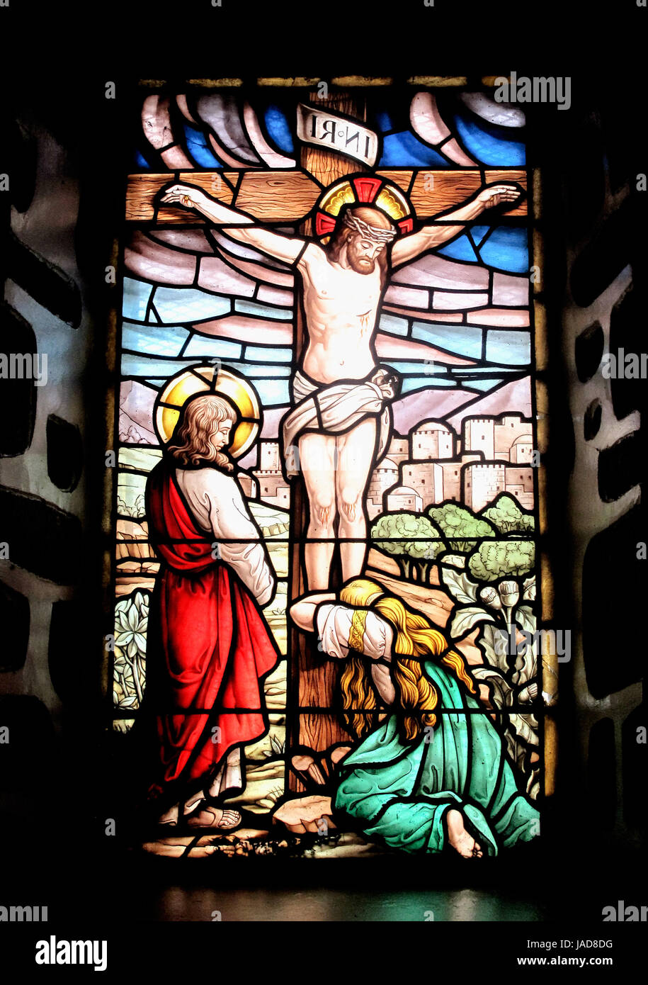 Colorful window with the image of the crucified Jesus and Mary crying Stock Photo - Alamy