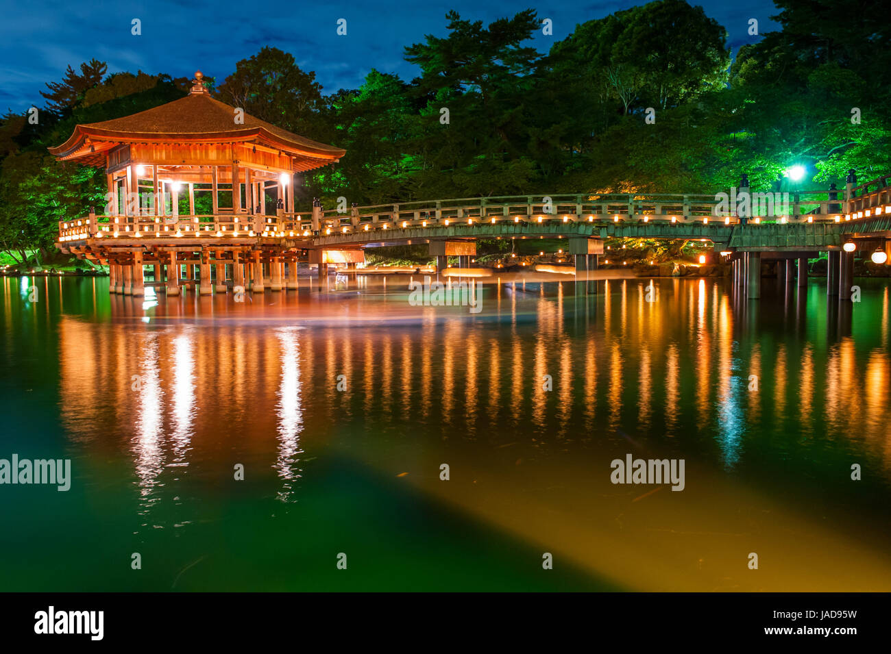 Nice japanese wooden gazebo is shortly after the sunset reflecting in ...