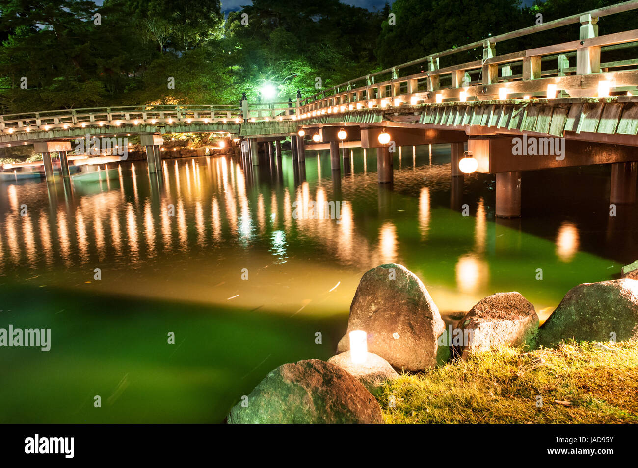 Nice japanese wooden bridge is shortly after the sunset reflecting in ...