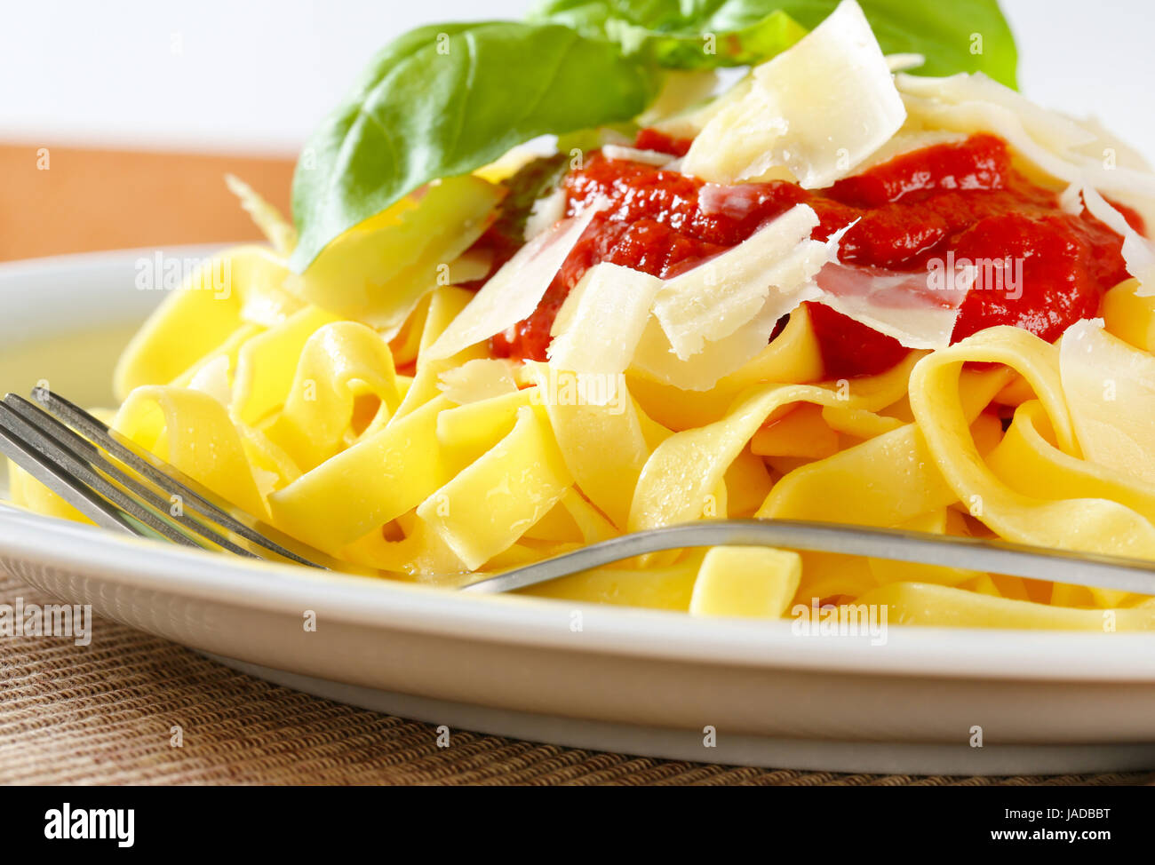 Tagliatelle pasta with tomato puree and Parmesan Stock Photo - Alamy