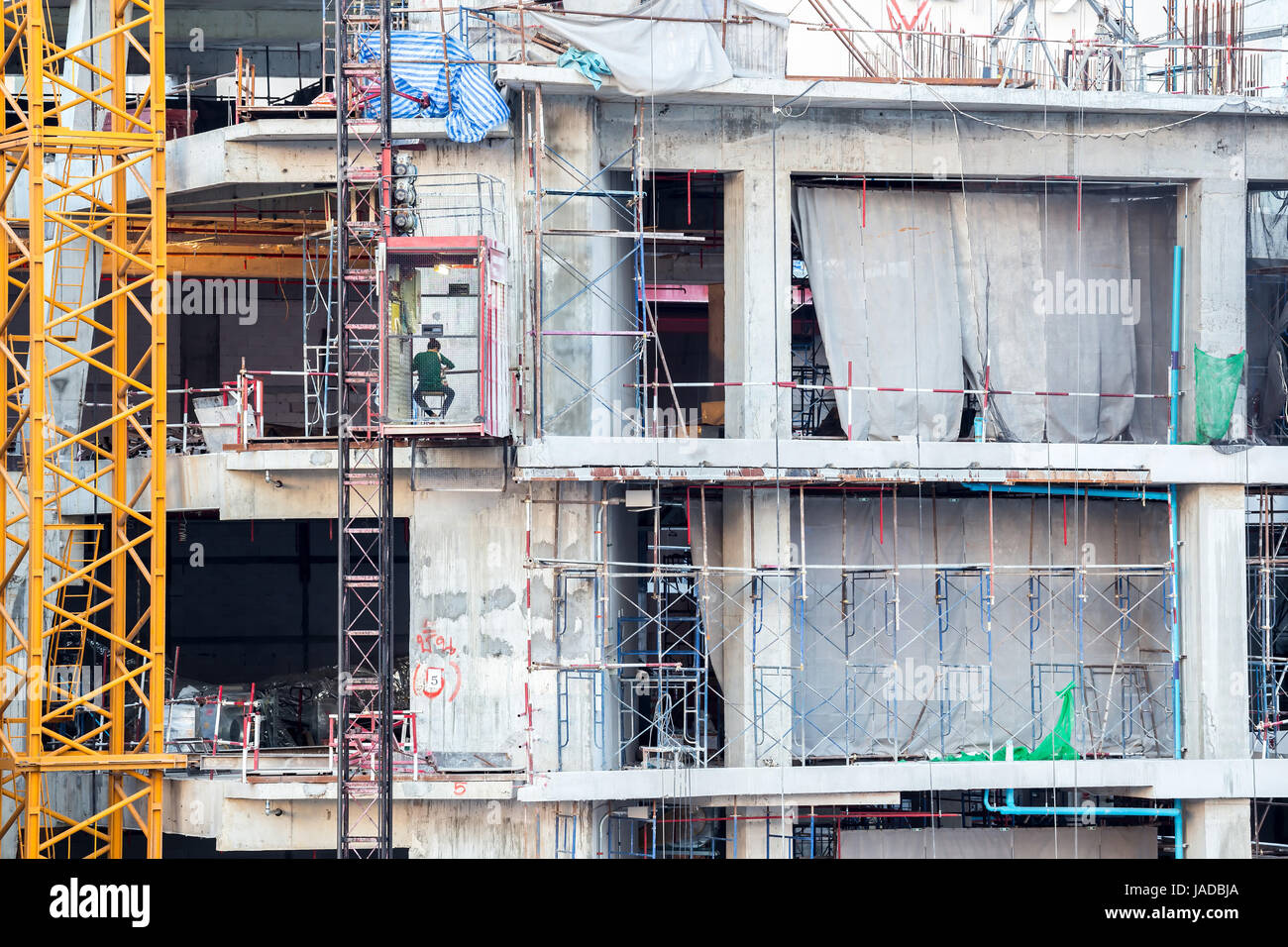 Worker in construction elevator lift Stock Photo - Alamy