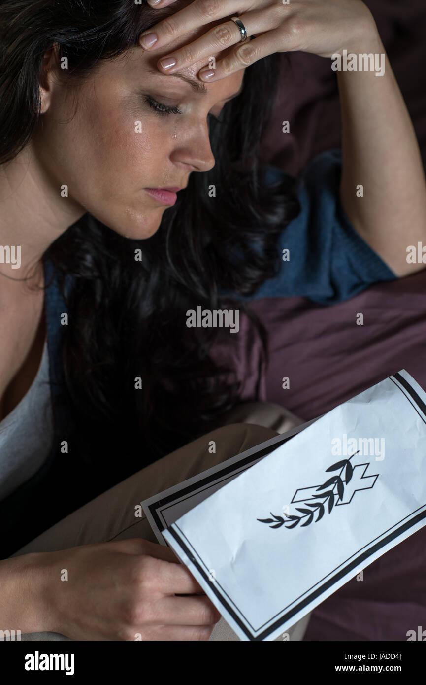 Close up portrait of mourning woman holding obituary Stock Photo - Alamy