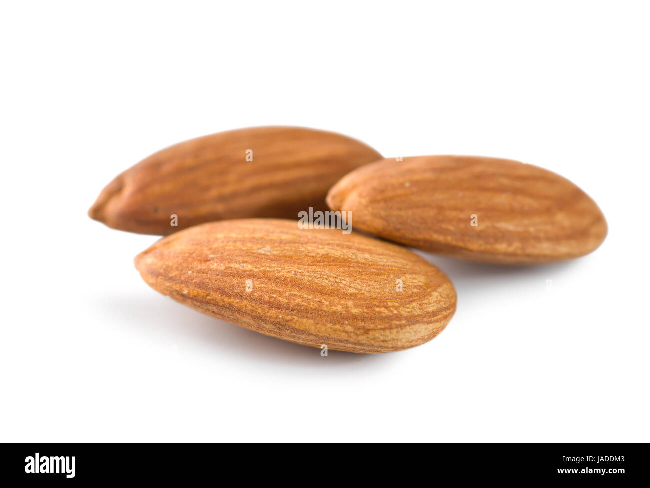 Three almond isolated on a white background Stock Photo - Alamy