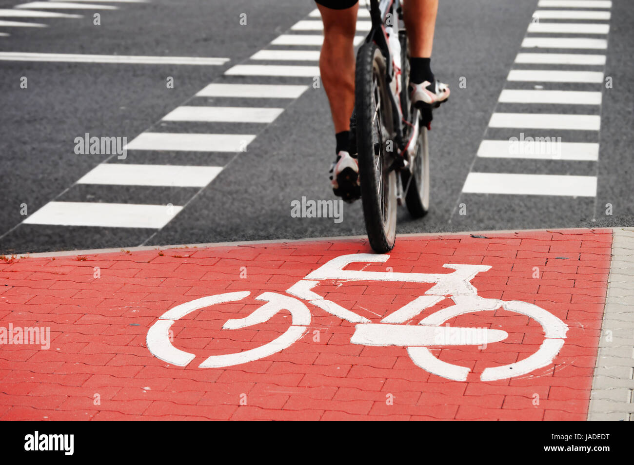Bicycle road sign and bike rider Stock Photo - Alamy