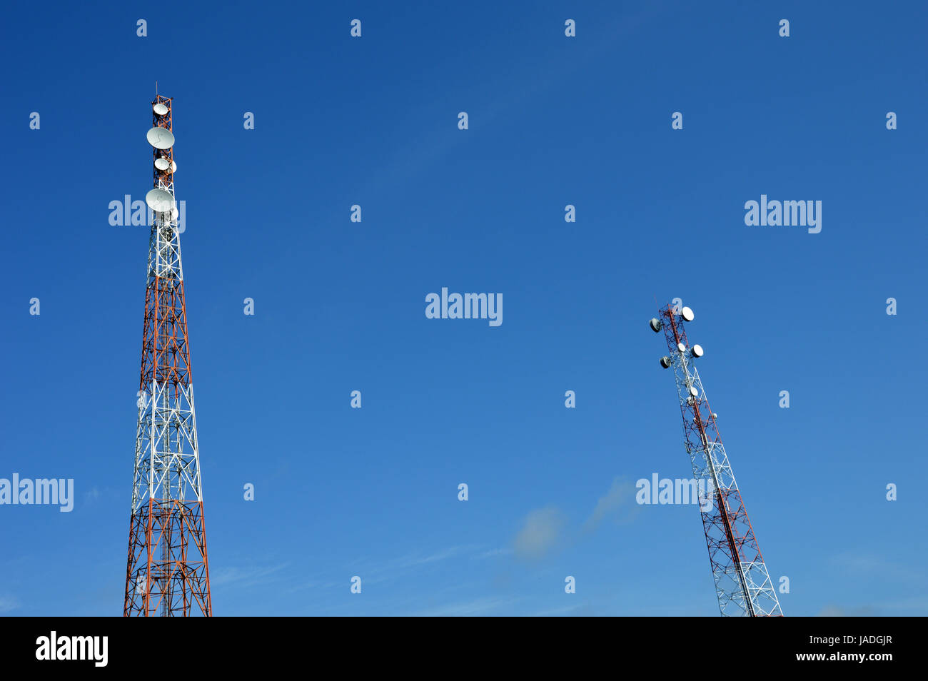two telecommunications tower against blue sky Stock Photo - Alamy