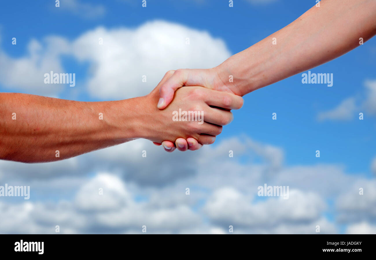 Strong handshake with a nice blue sky background Stock Photo - Alamy
