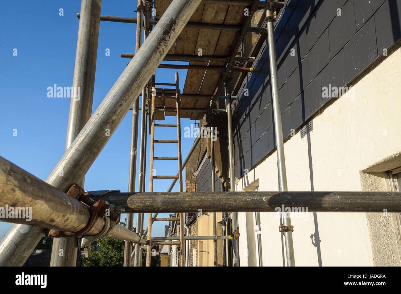 Scaffolding against a house wall Stock Photo - Alamy