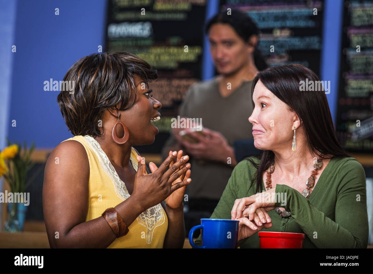 Enthusiastic Hispanic woman talking with friend in cafe Stock Photo - Alamy
