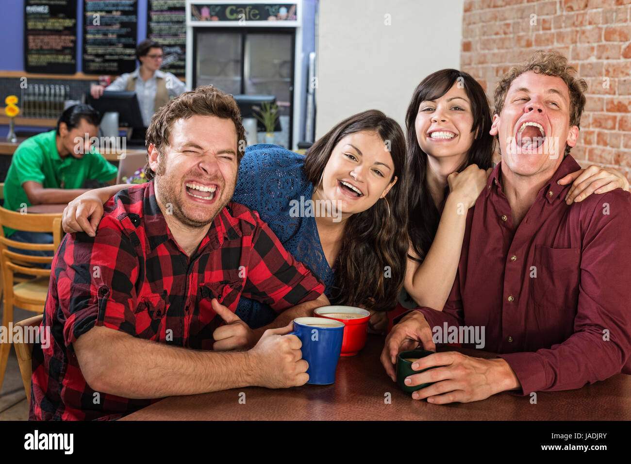 Laughing group of cheerful friends in bistro Stock Photo - Alamy
